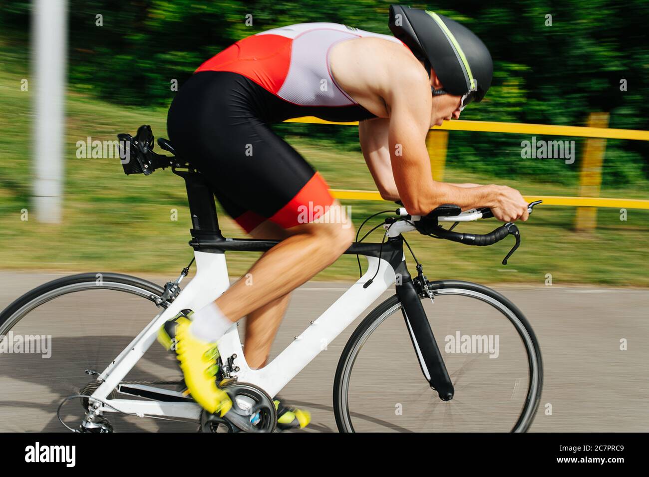 Determined man putting a lot of effort in racing on his bicycle. Side ...