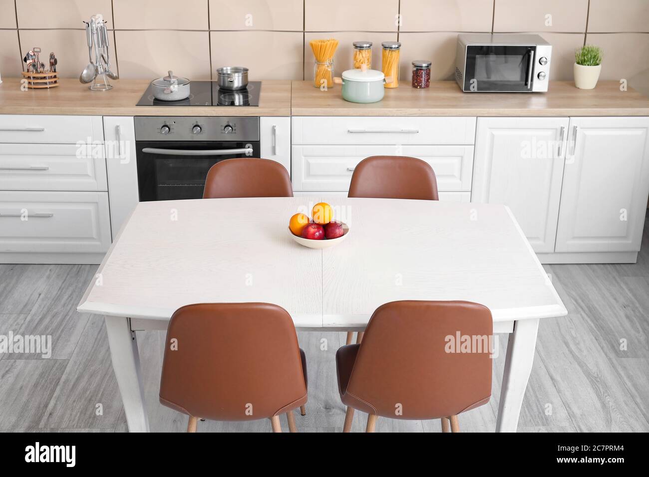Dining table in interior of modern kitchen Stock Photo - Alamy