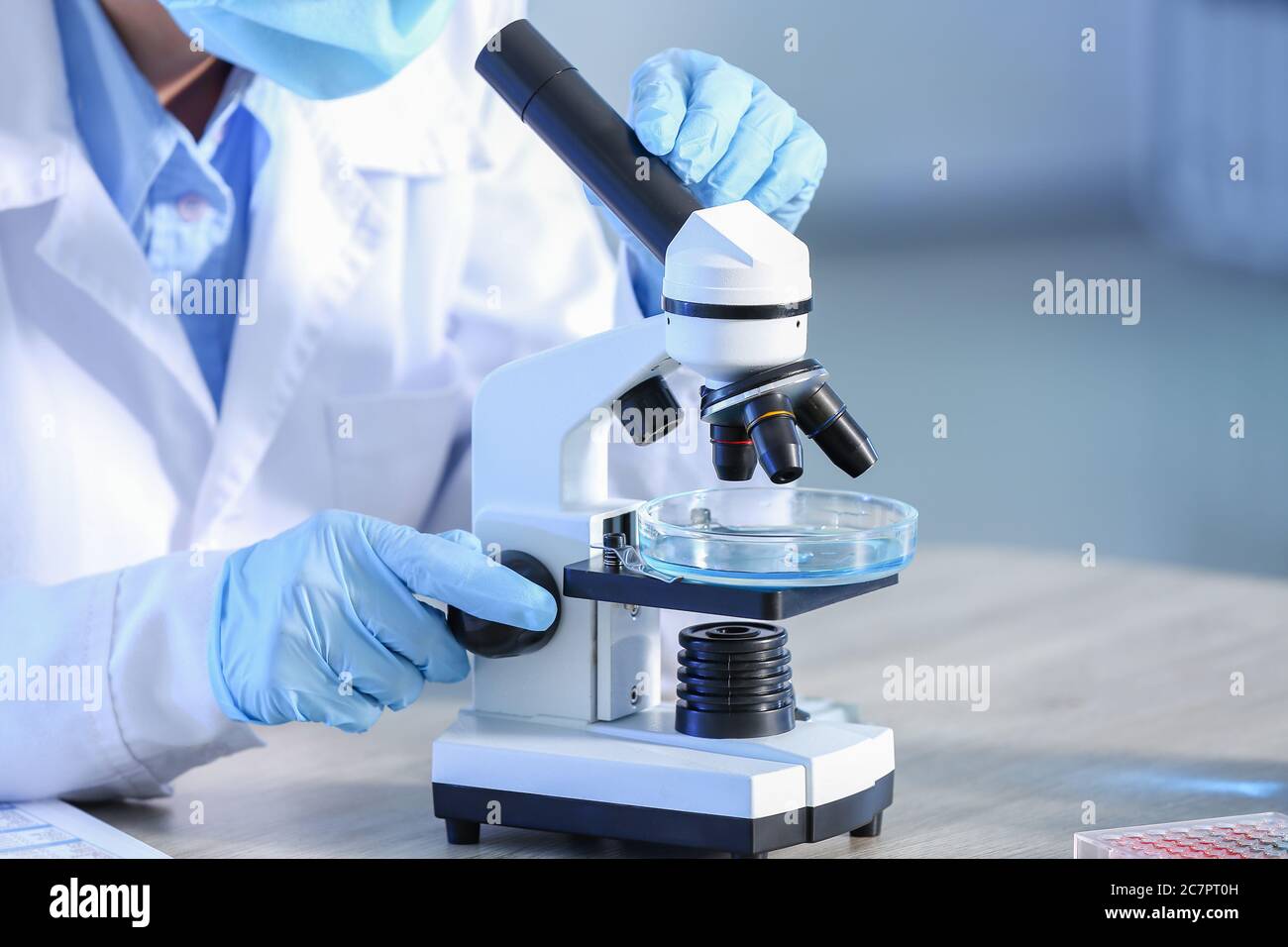 Scientist working with microscope in laboratory Stock Photo - Alamy