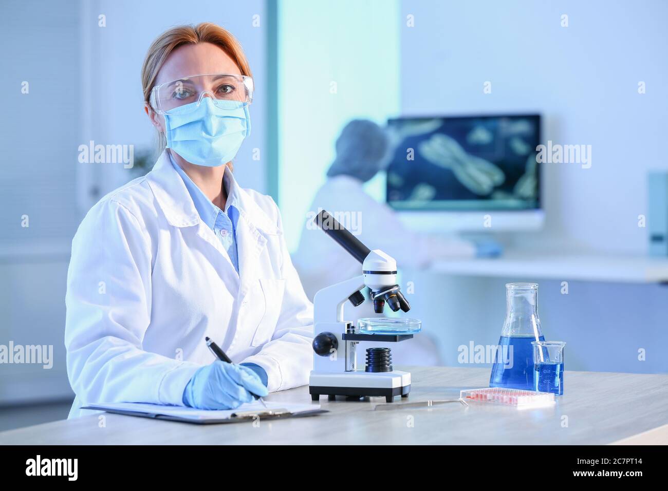 Scientist working with microscope in laboratory Stock Photo - Alamy