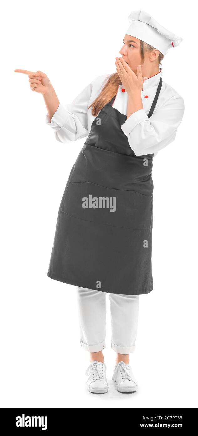 Shocked female chef pointing at something on white background Stock ...