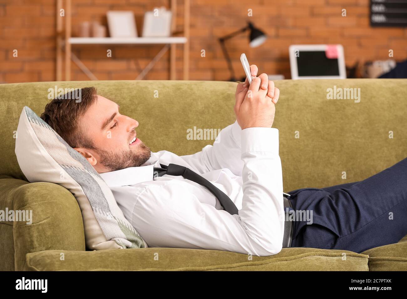 Young businessman resting at home after long working day Stock Photo ...
