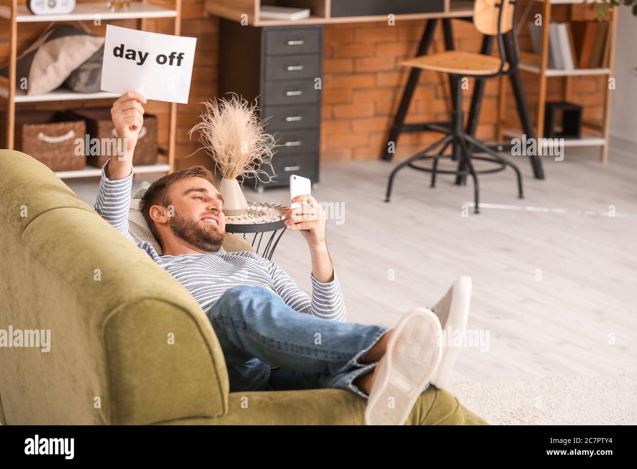 Lazy man with mobile phone spending day off at home Stock Photo - Alamy