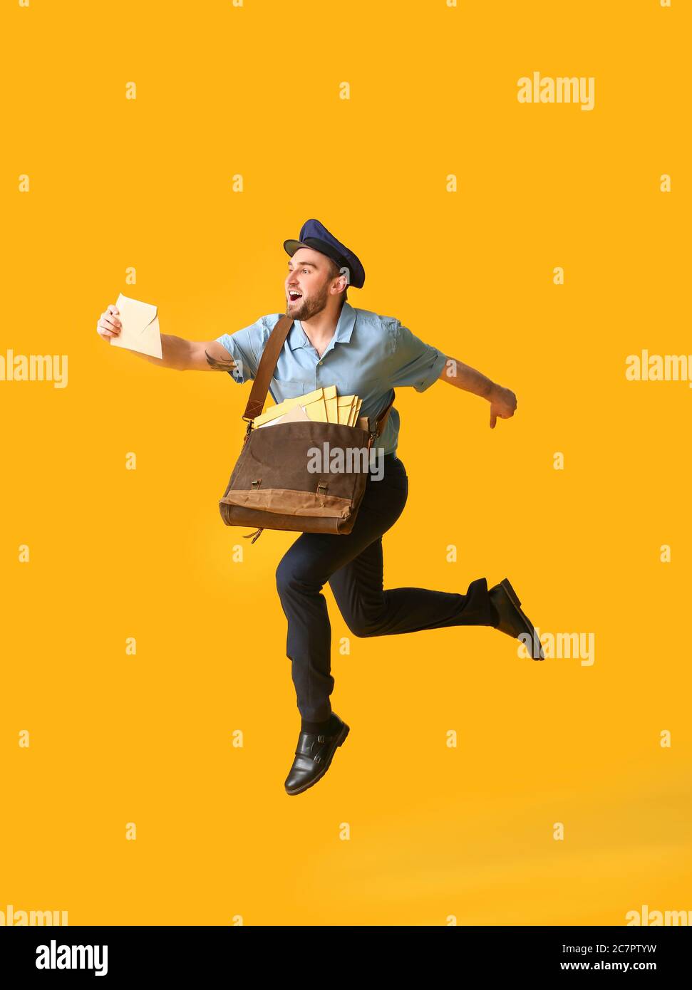 Handsome running postman on color background Stock Photo - Alamy