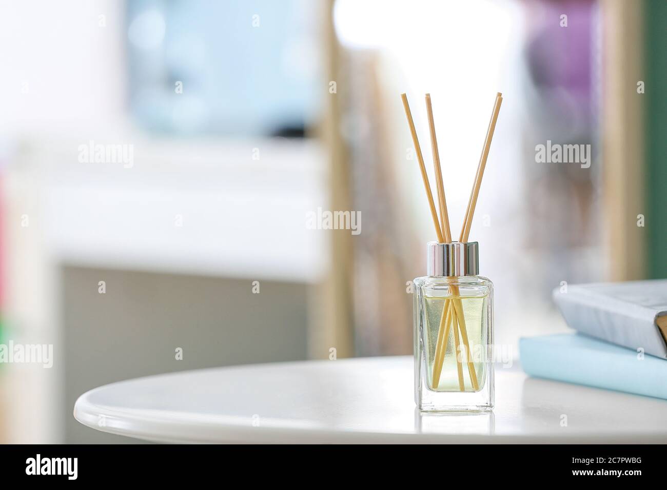 Reed diffuser on table in room Stock Photo - Alamy