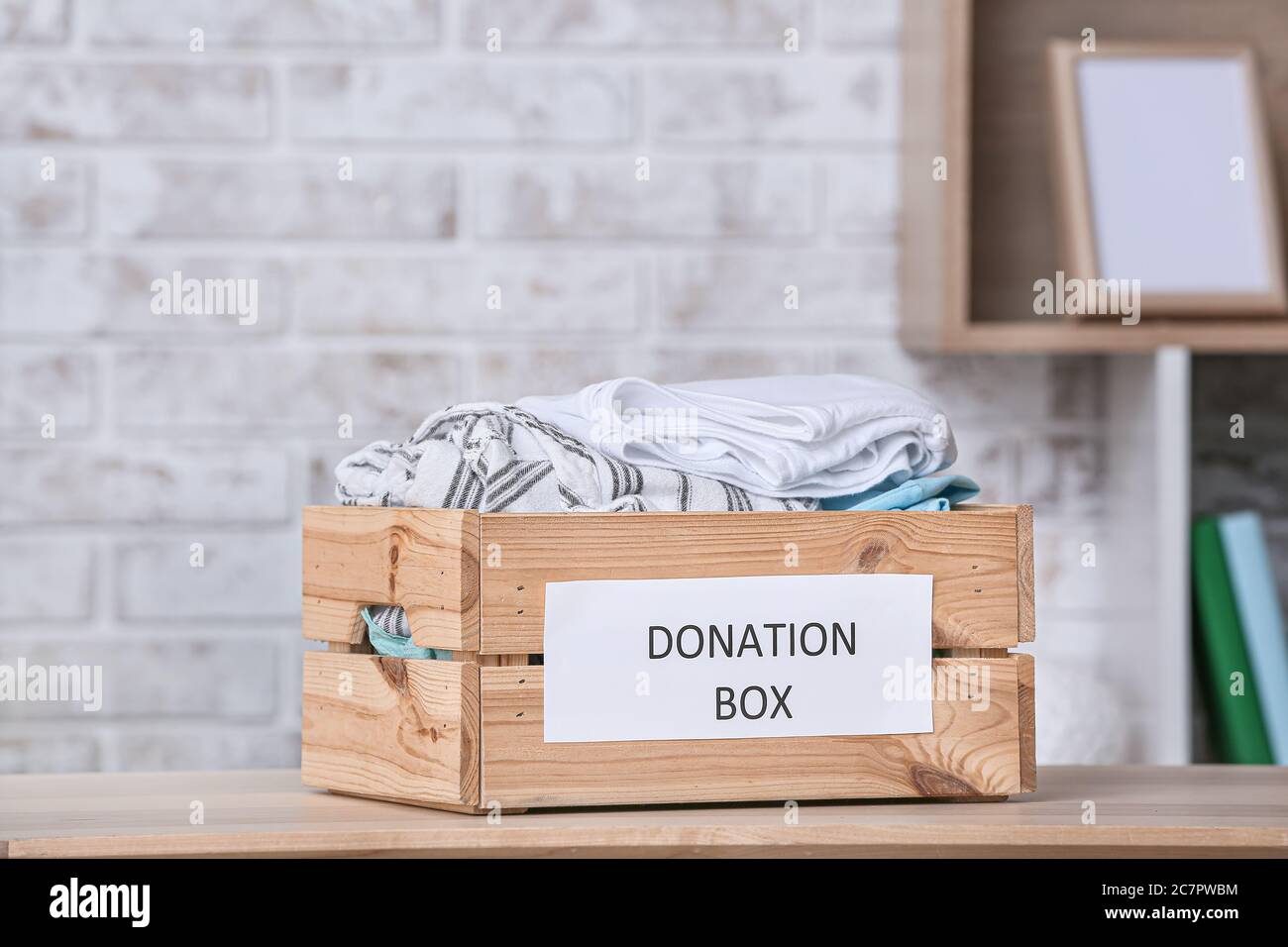 Box with donations on table in room Stock Photo - Alamy
