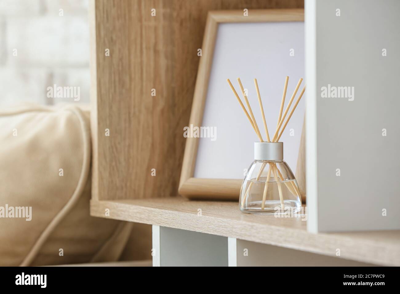 Reed diffuser on shelf in room Stock Photo - Alamy