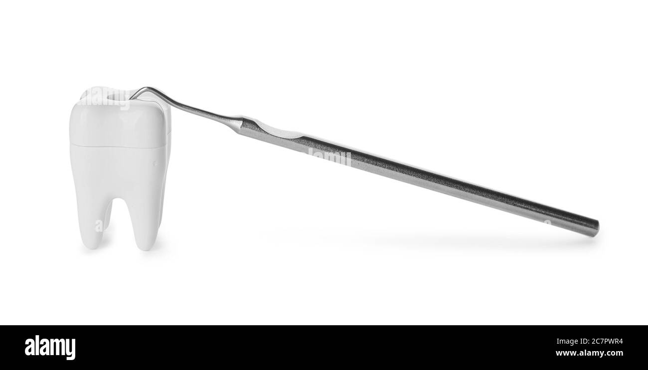 Dental tool with tooth on white background Stock Photo - Alamy