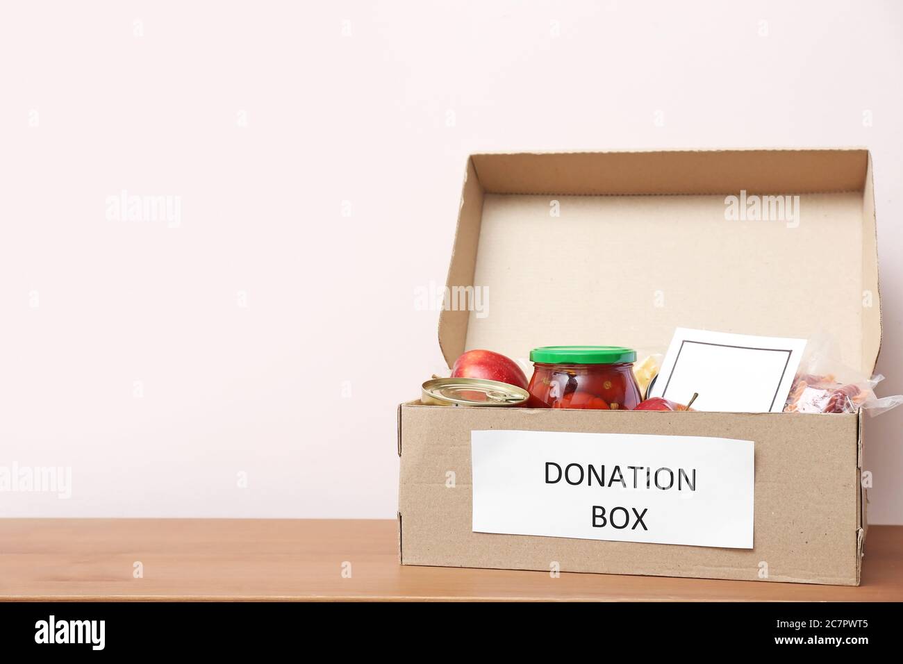 Box with donations on table Stock Photo - Alamy