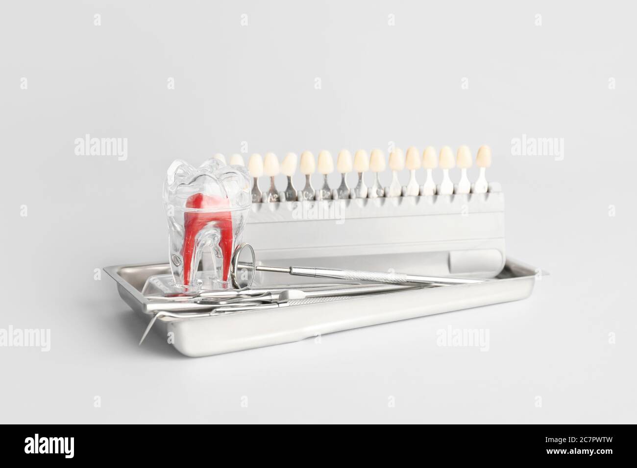 Dental tools and teeth color samples on light background Stock Photo ...