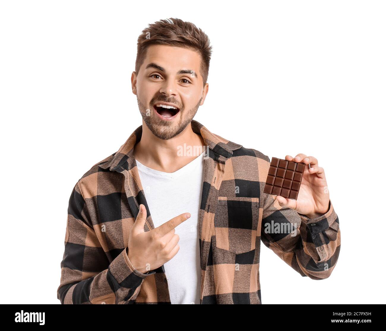 Handsome young man with tasty chocolate on white background Stock Photo ...