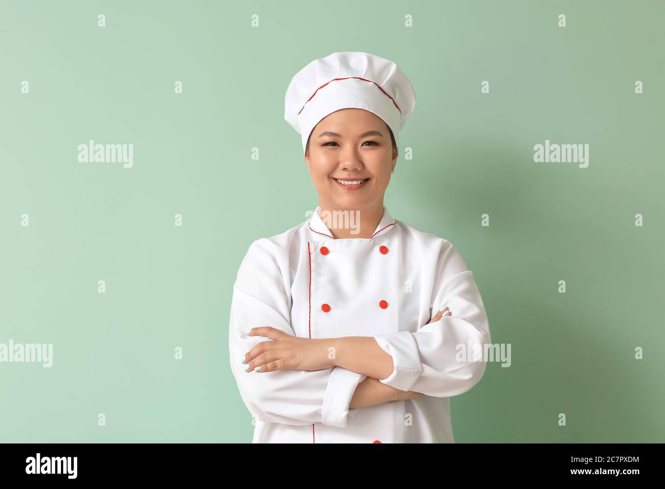 Beautiful Asian chef on color background Stock Photo - Alamy