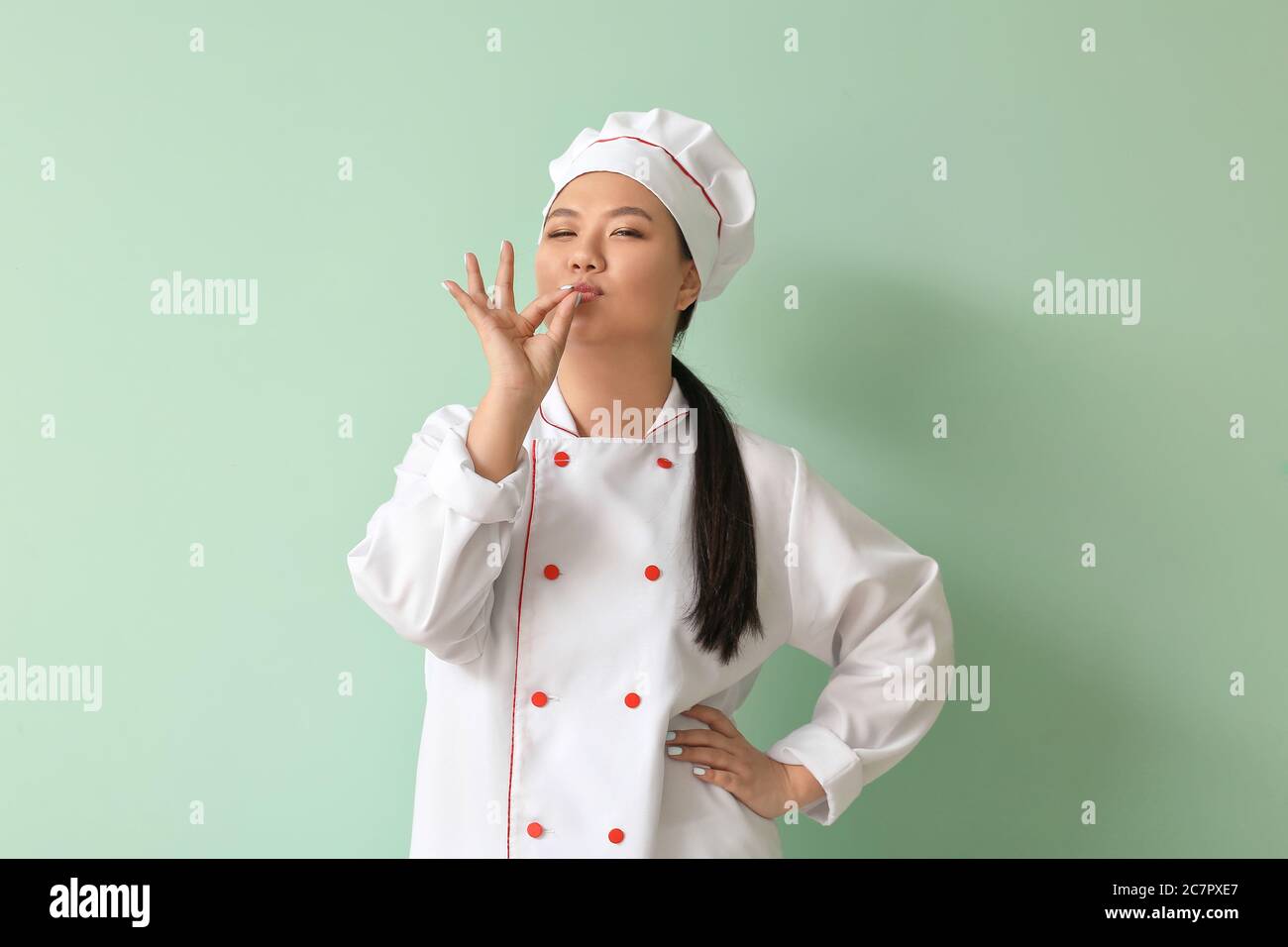 Beautiful Asian chef on color background Stock Photo - Alamy