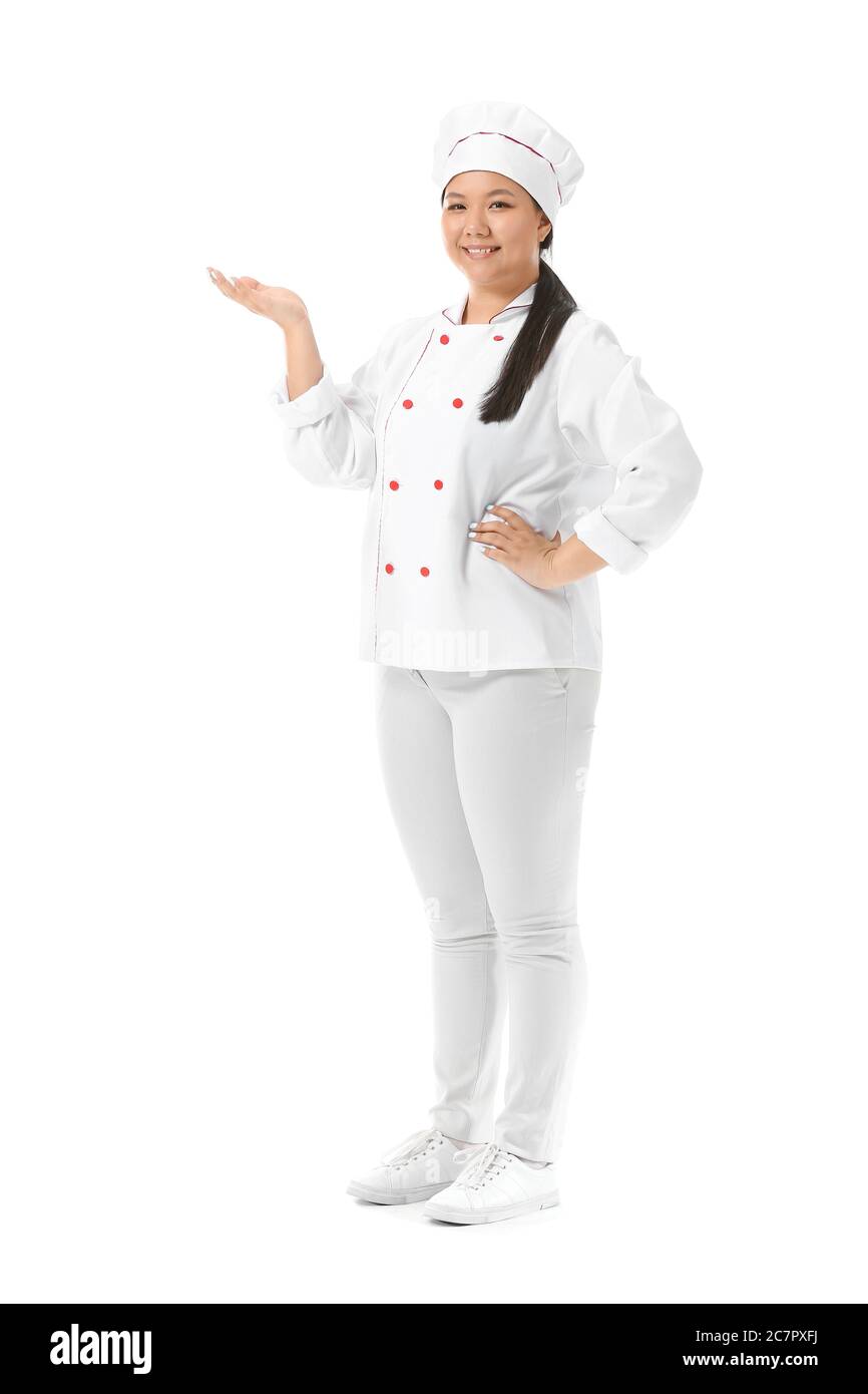 Beautiful Asian chef showing something on white background Stock Photo ...