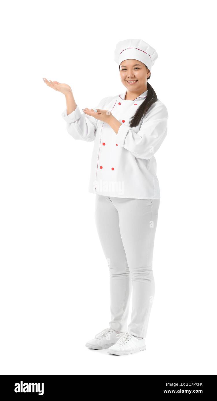 Beautiful Asian chef showing something on white background Stock Photo ...