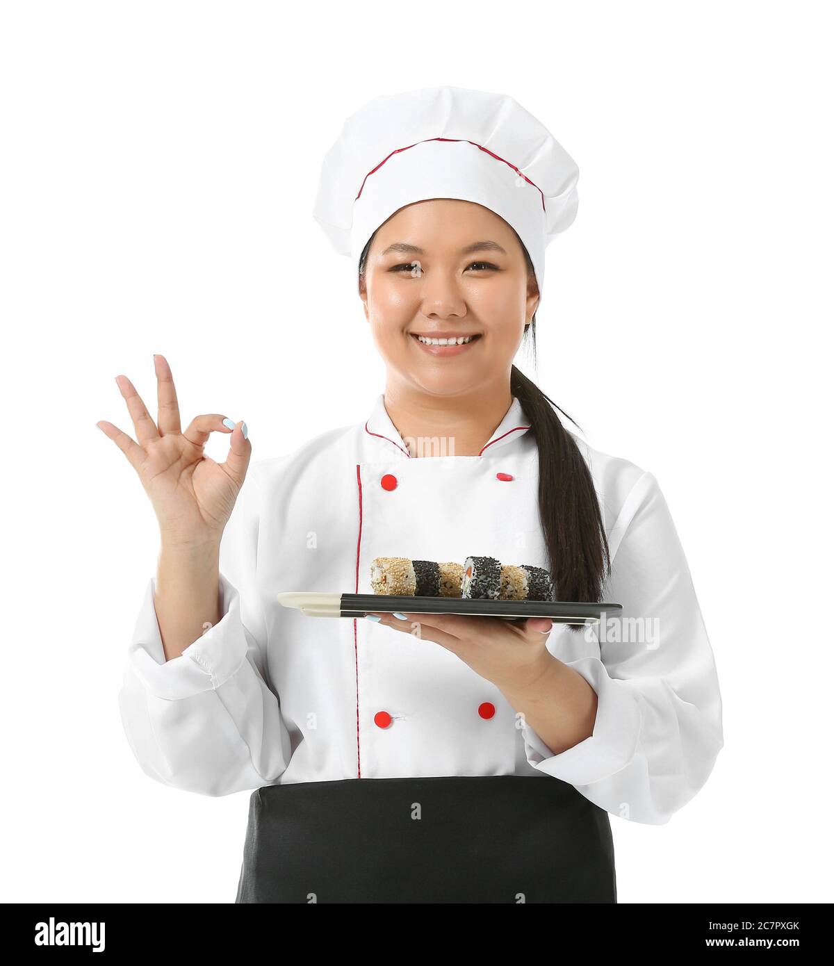 Beautiful Asian chef with sushi rolls showing OK gesture on white ...