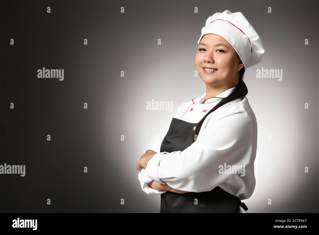 Beautiful Asian chef on dark background Stock Photo - Alamy