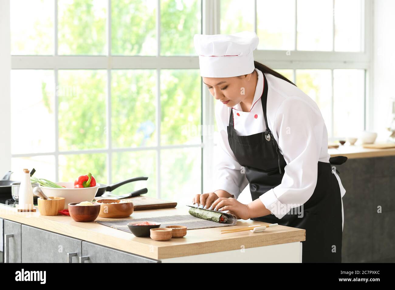 Beautiful Asian chef cooking in kitchen Stock Photo - Alamy