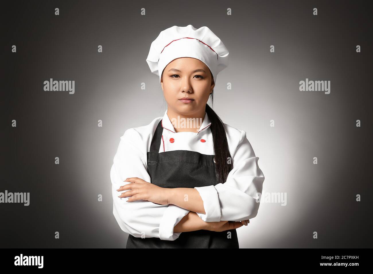 Beautiful Asian chef on dark background Stock Photo - Alamy
