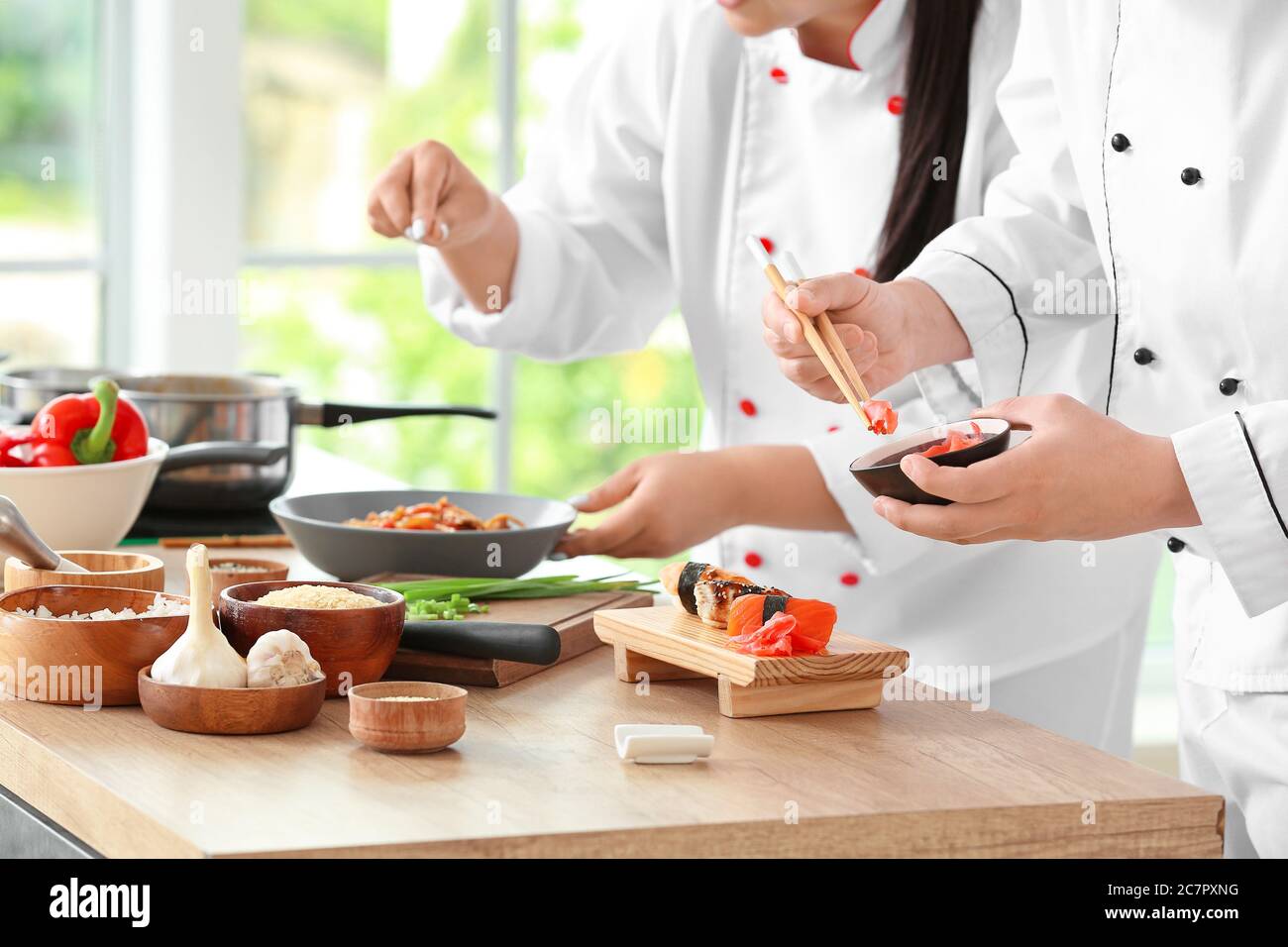 Asian chefs cooking together in kitchen Stock Photo - Alamy