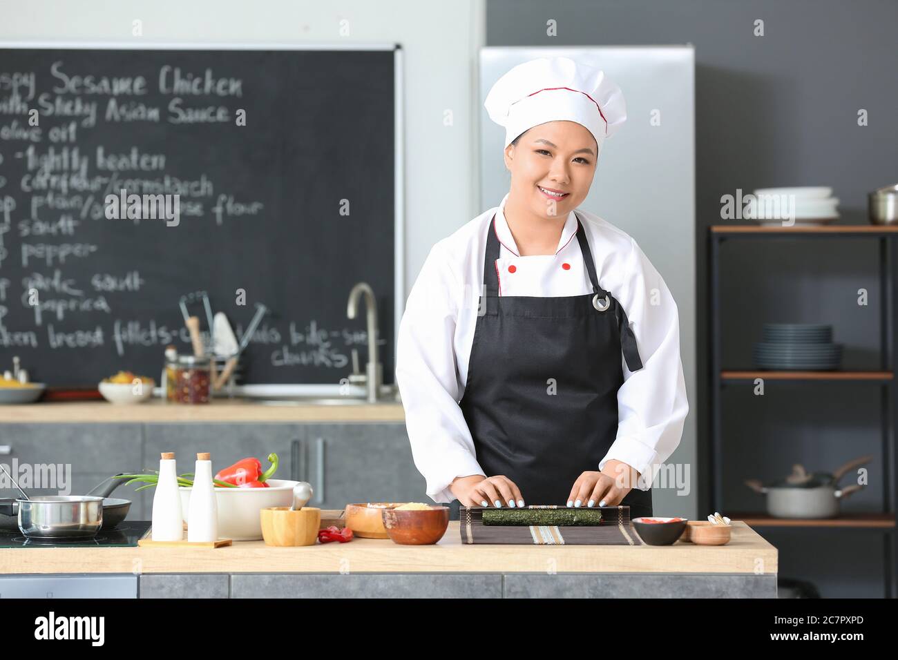 Beautiful Asian chef cooking in kitchen Stock Photo - Alamy
