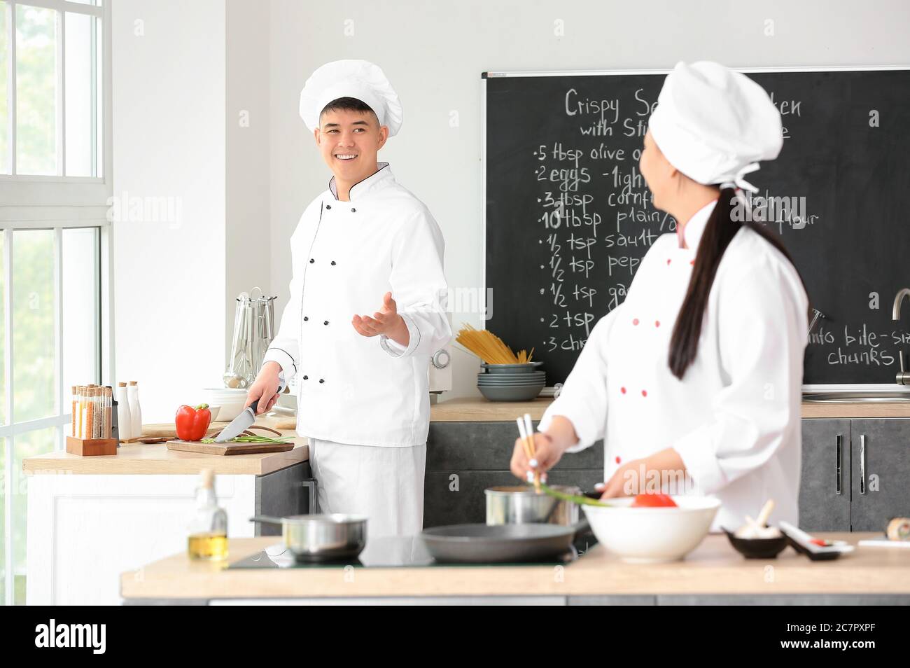 Asian chefs cooking together in kitchen Stock Photo - Alamy