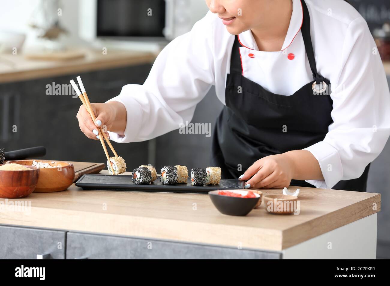 Beautiful Asian chef cooking in kitchen Stock Photo - Alamy