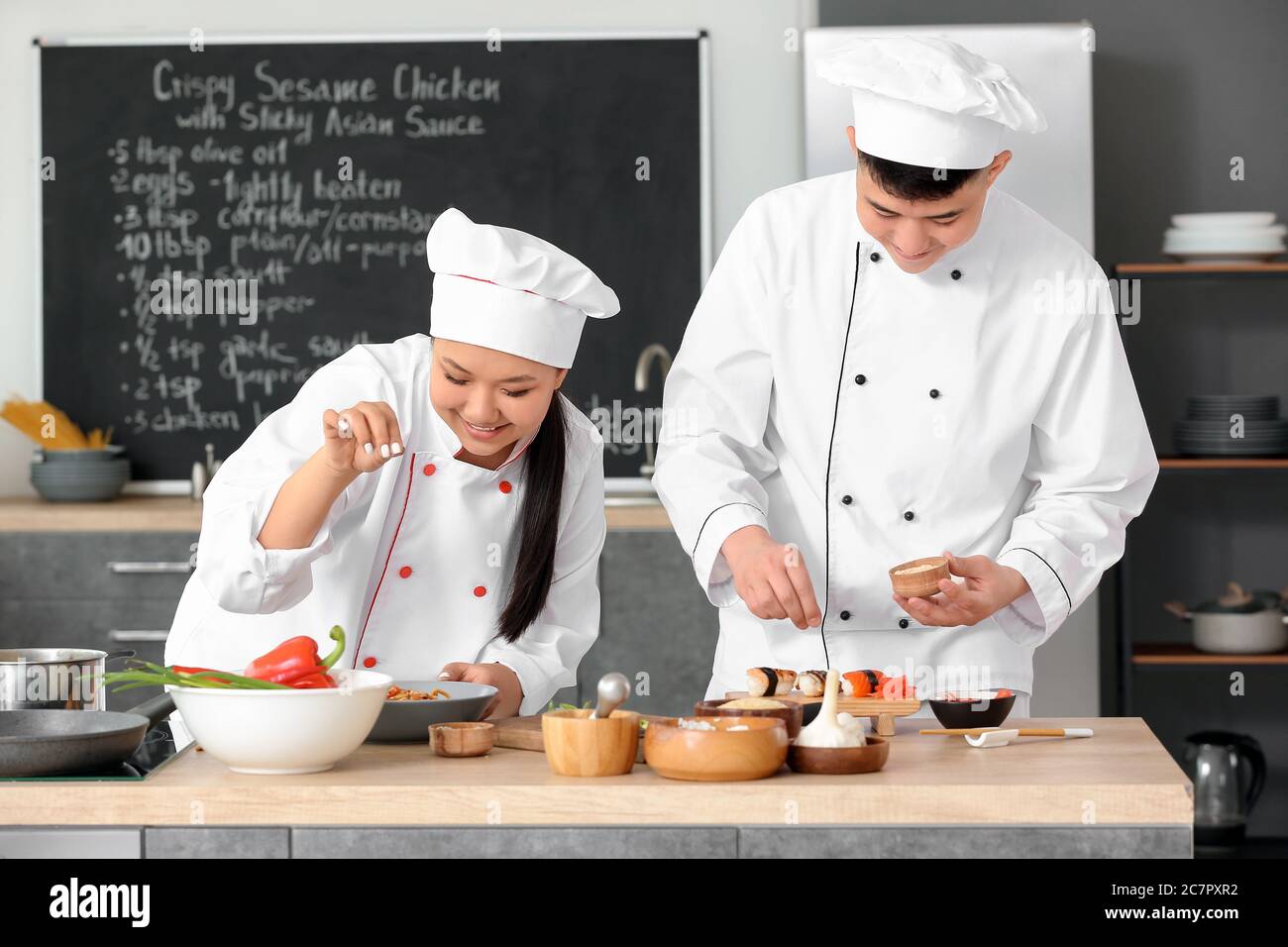 Asian chefs cooking together in kitchen Stock Photo - Alamy