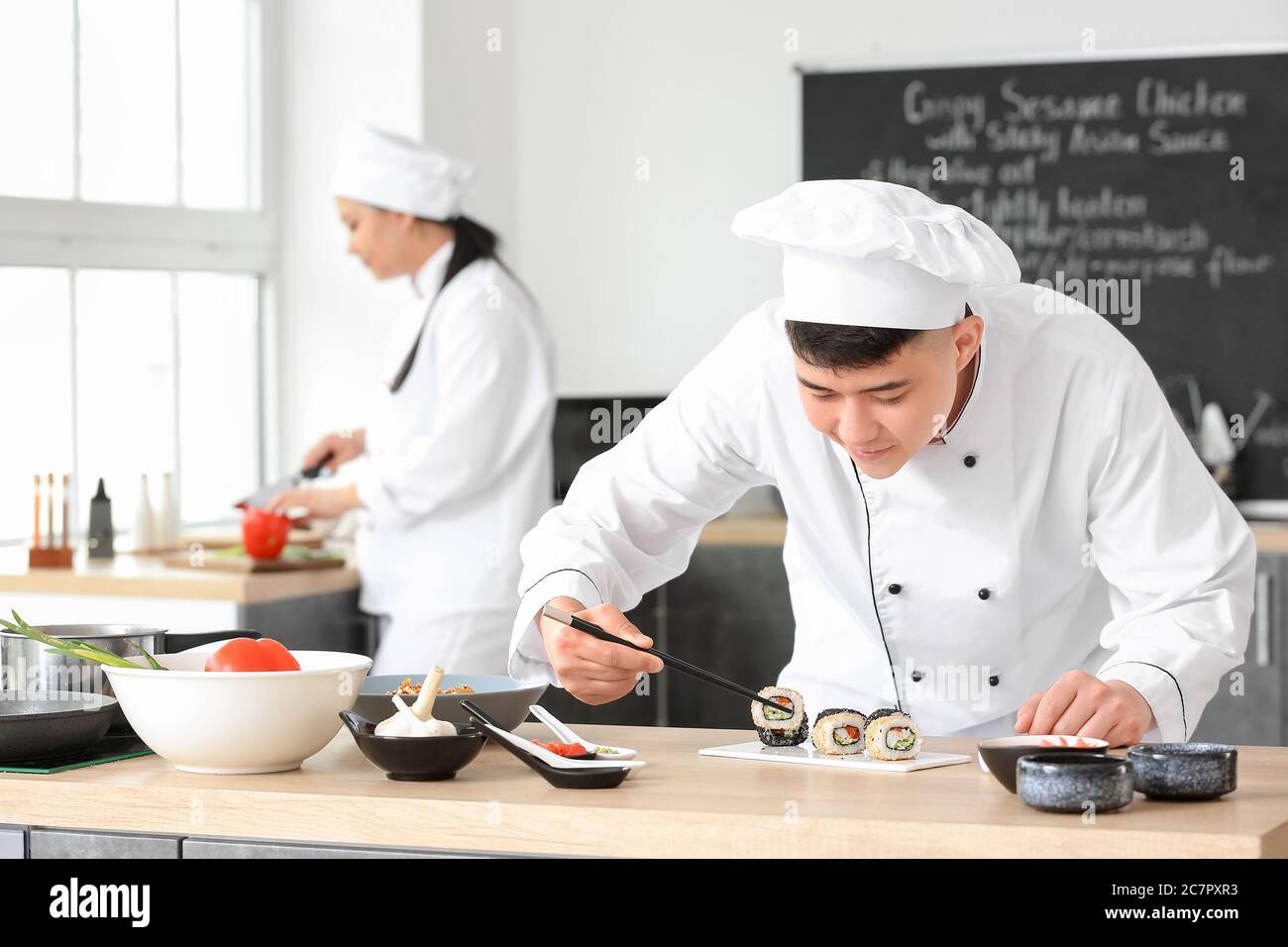 Asian chefs cooking together in kitchen Stock Photo - Alamy