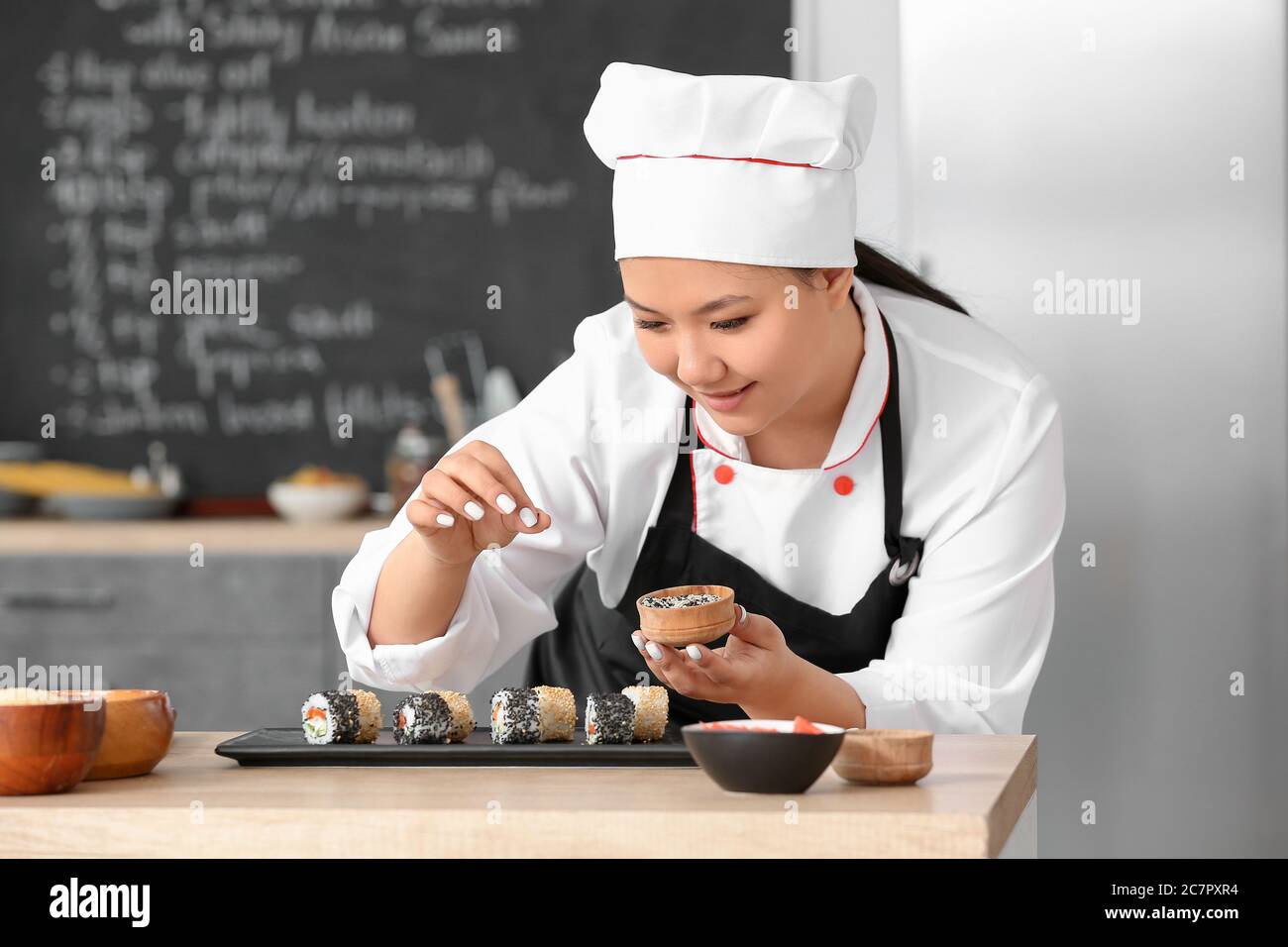 Beautiful Asian chef cooking in kitchen Stock Photo - Alamy