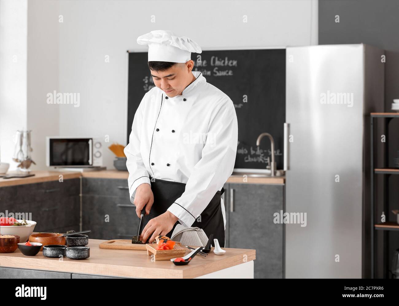 Handsome asian chef cooking hi-res stock photography and images - Alamy