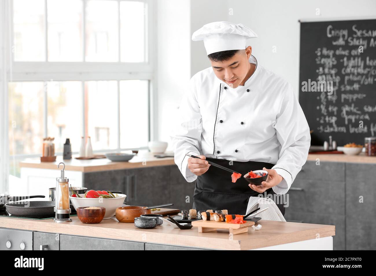 Handsome asian chef cooking hi-res stock photography and images - Alamy