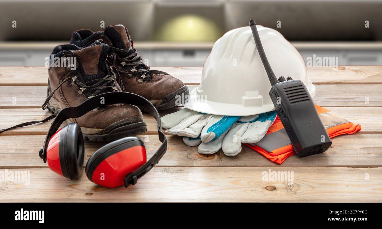 Work safety protection equipment. Industrial protective gear on wooden ...