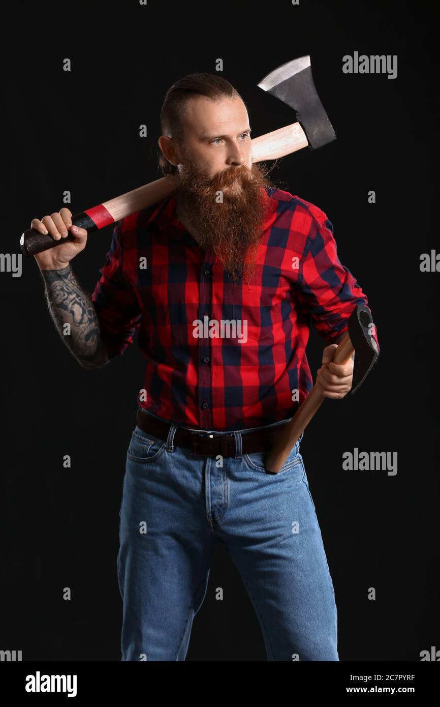 Handsome lumberjack on dark background Stock Photo - Alamy