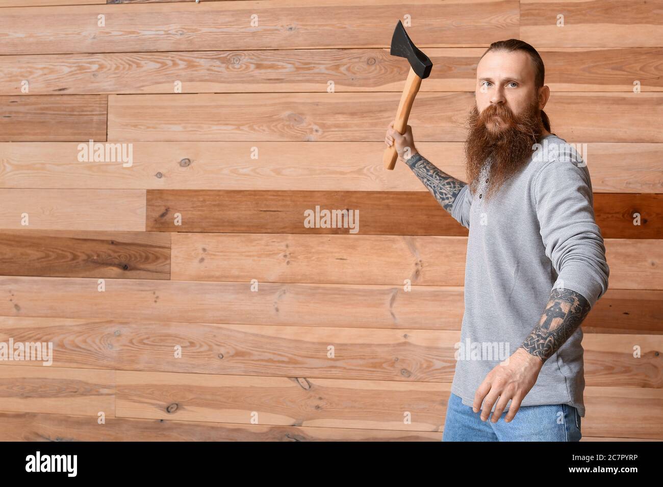 Handsome lumberjack on wooden background Stock Photo - Alamy