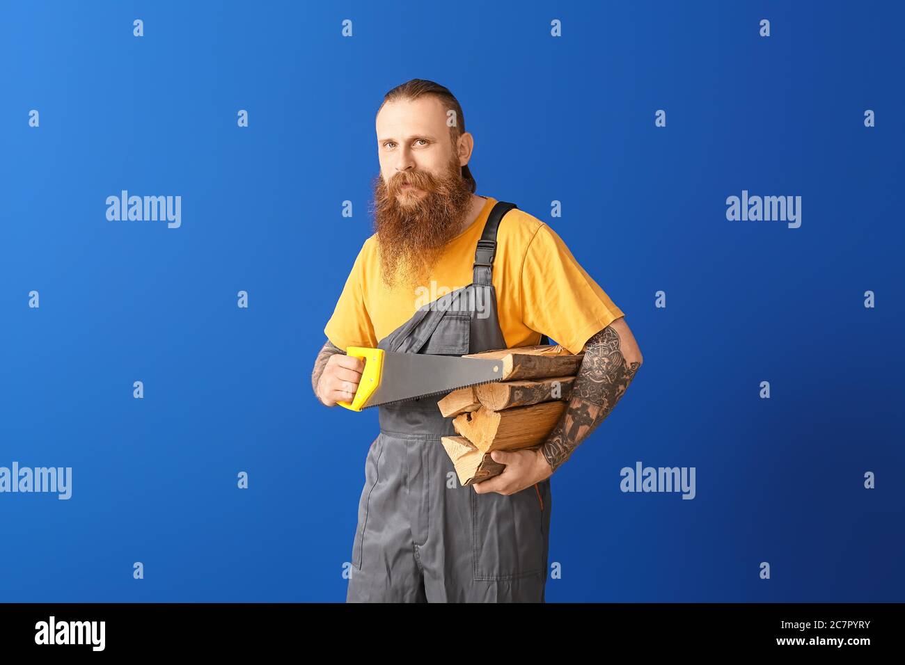 Handsome lumberjack on color background Stock Photo - Alamy