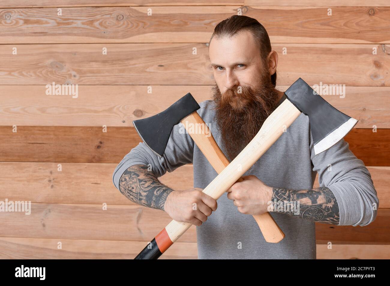 Handsome lumberjack on wooden background Stock Photo - Alamy