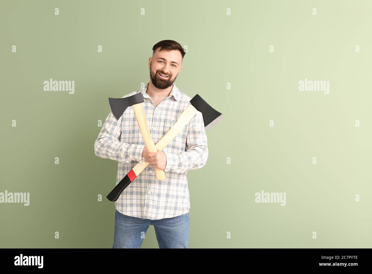 Handsome lumberjack on color background Stock Photo - Alamy