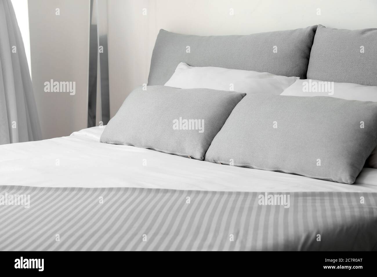 Big comfortable bed in hotel room Stock Photo - Alamy