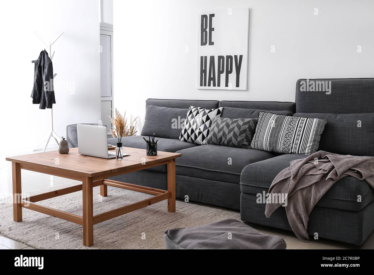 Interior of modern room with table and sofa Stock Photo - Alamy