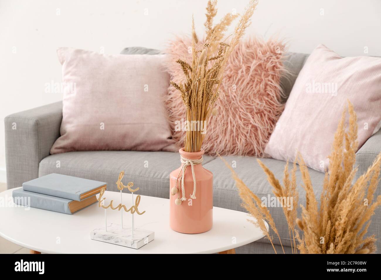 Interior of modern room with table and sofa Stock Photo - Alamy