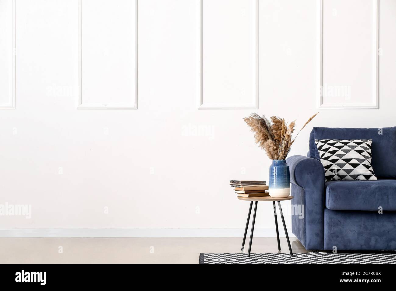 Interior of modern room with table and sofa Stock Photo - Alamy