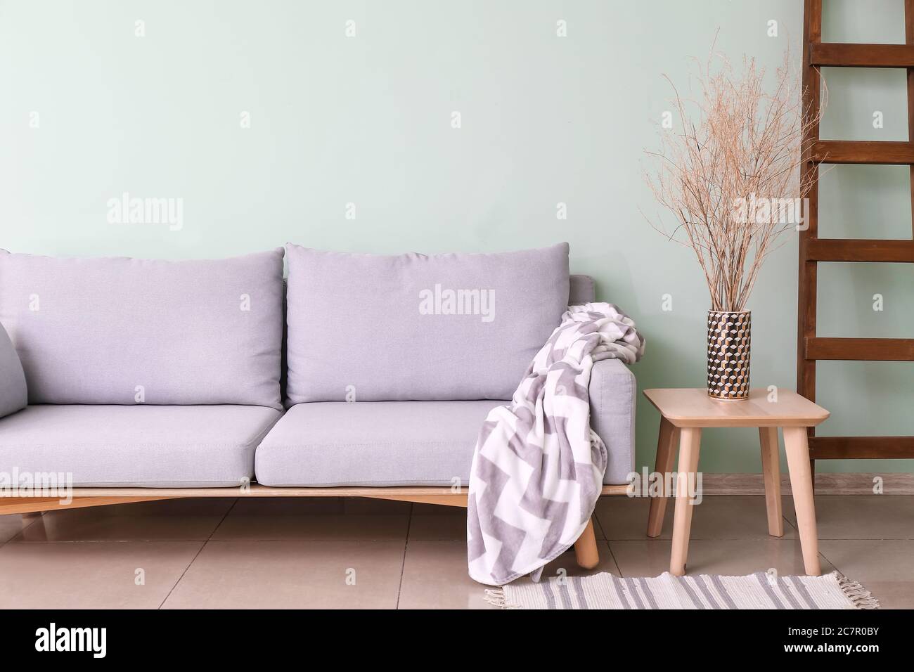 Interior of modern room with table and sofa Stock Photo - Alamy