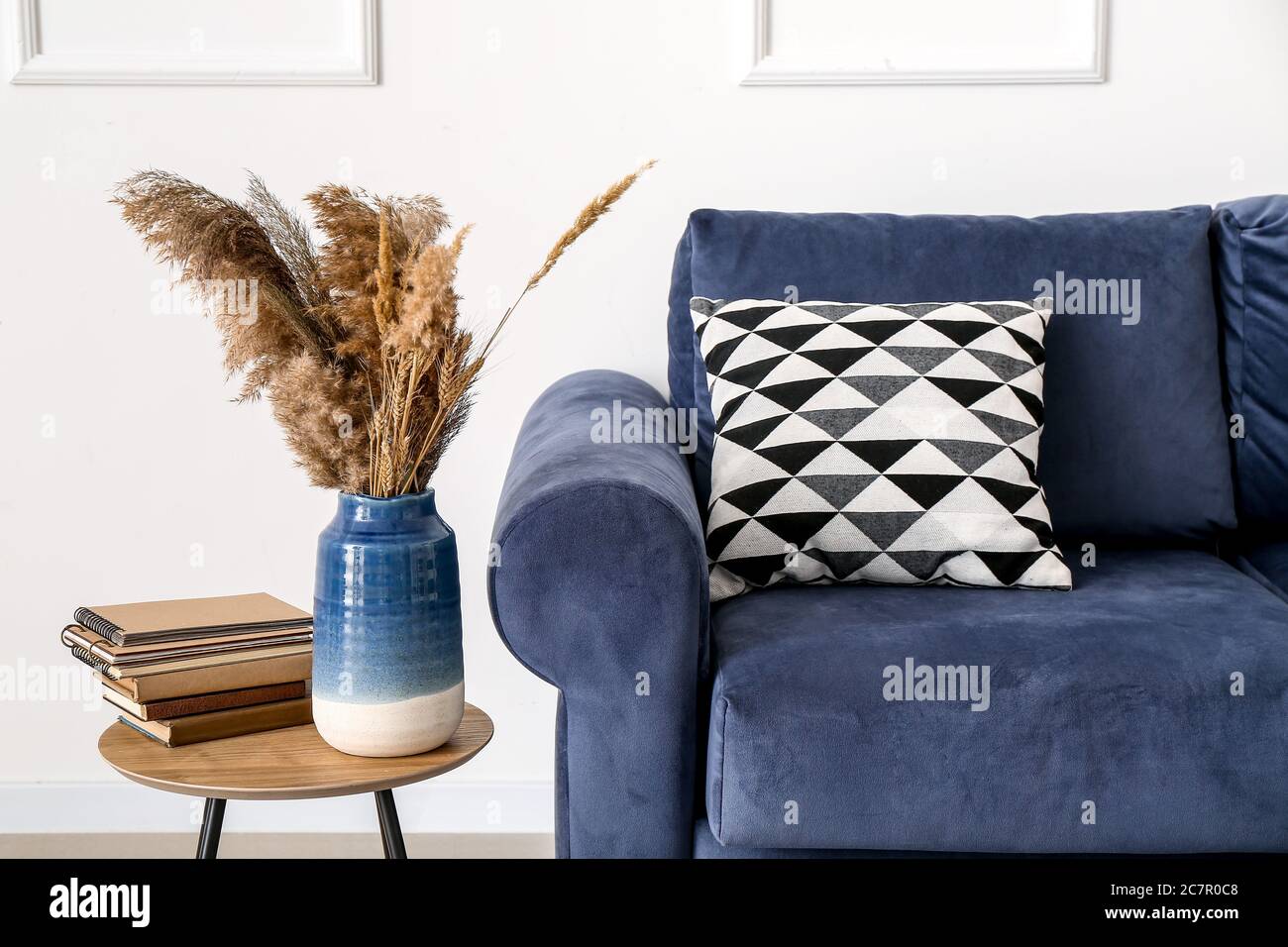 Interior of modern room with table and sofa Stock Photo - Alamy