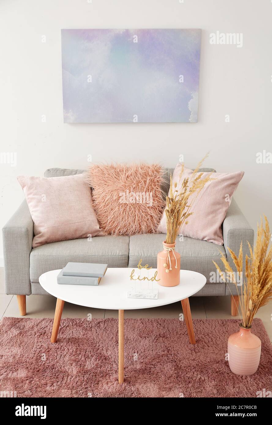 Interior of modern room with table and sofa Stock Photo - Alamy