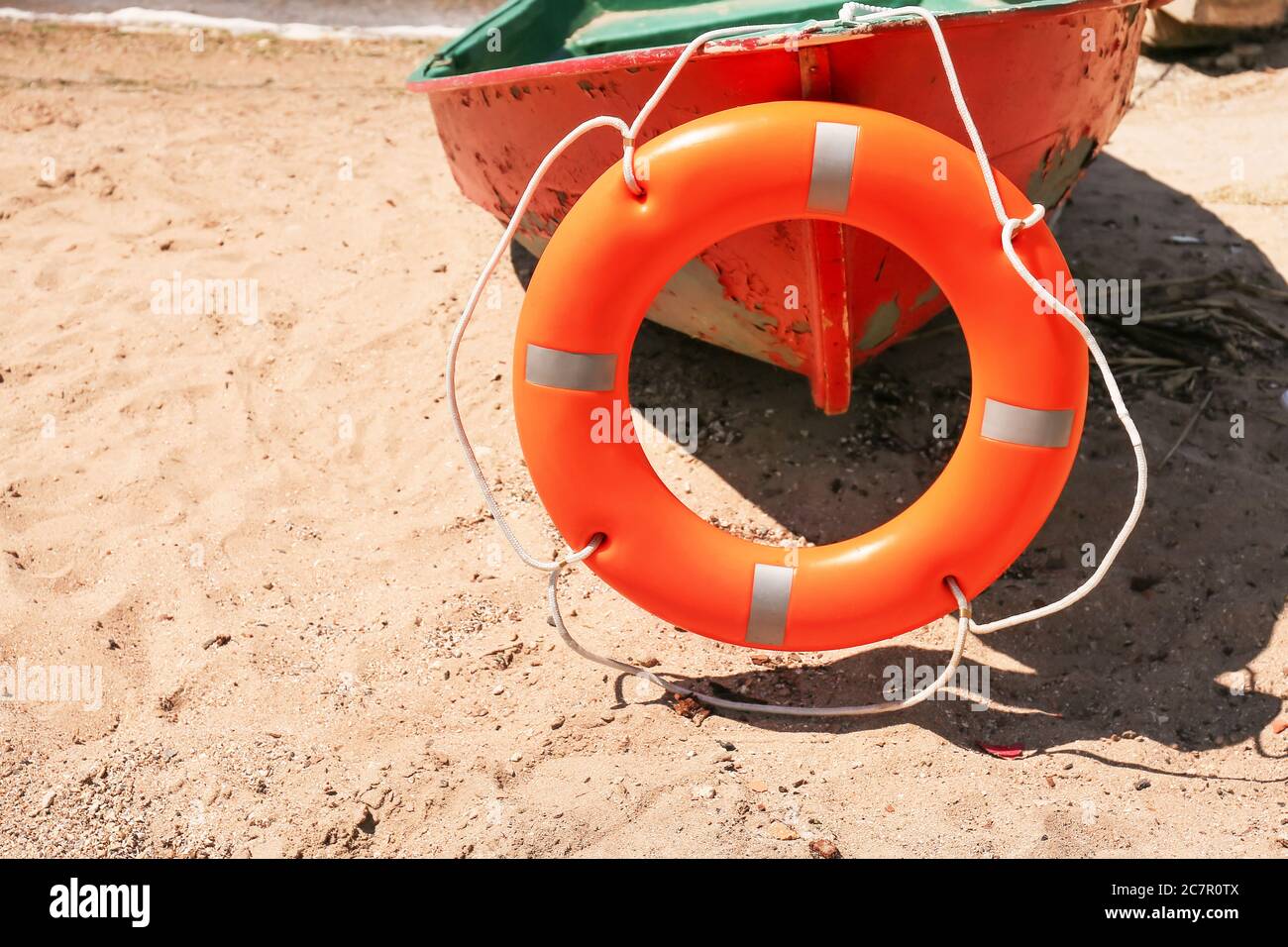 Boat with lifebuoy ring on coast Stock Photo - Alamy