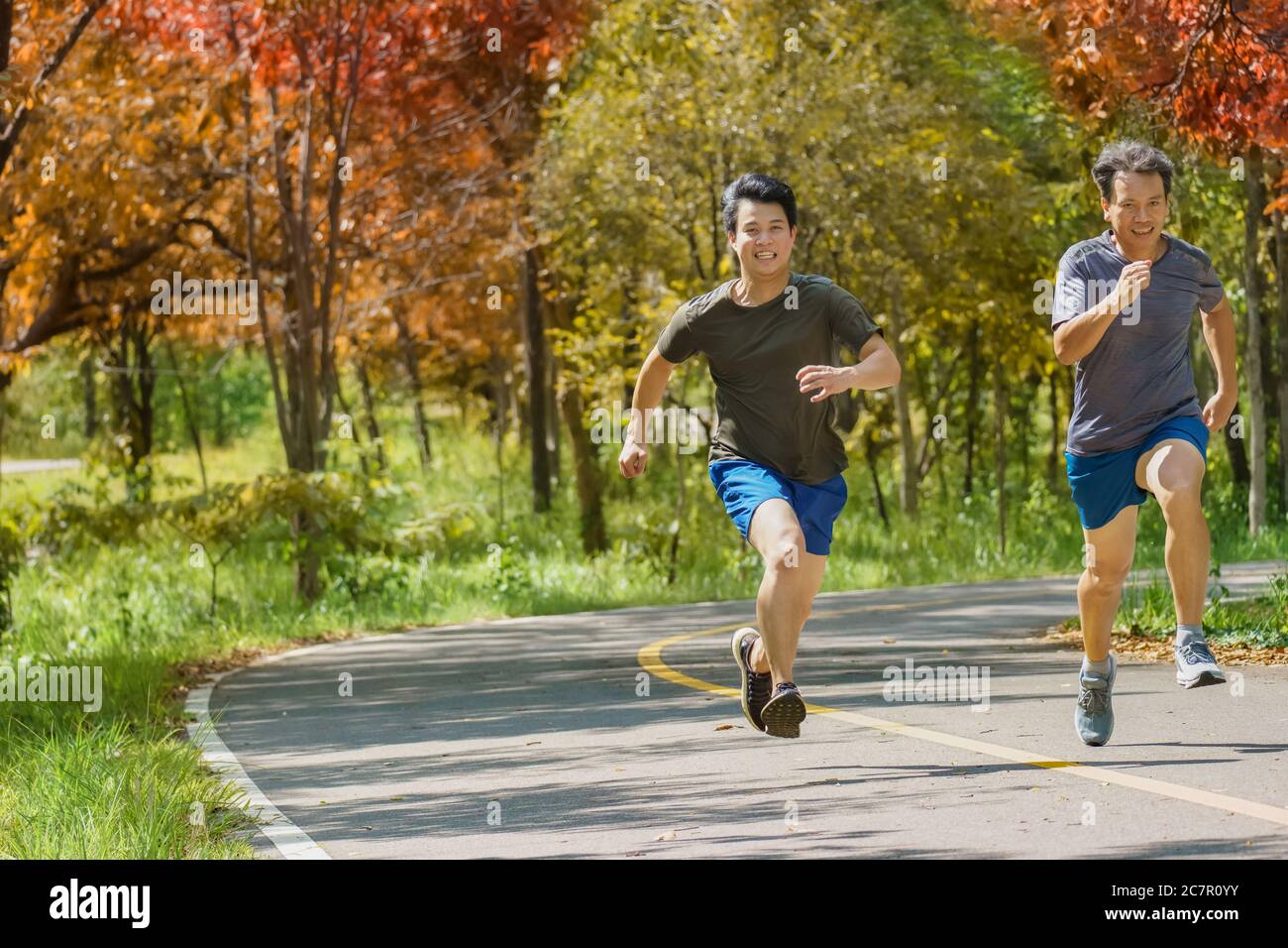 Father and adult son running together on the park path Stock Photo - Alamy
