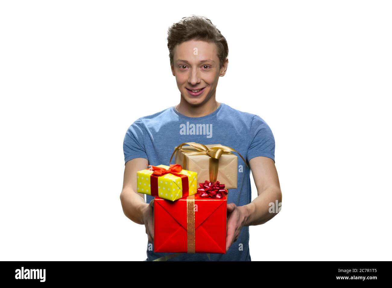 Handsome teen boy is holding wrapped gift boxes Stock Photo - Alamy