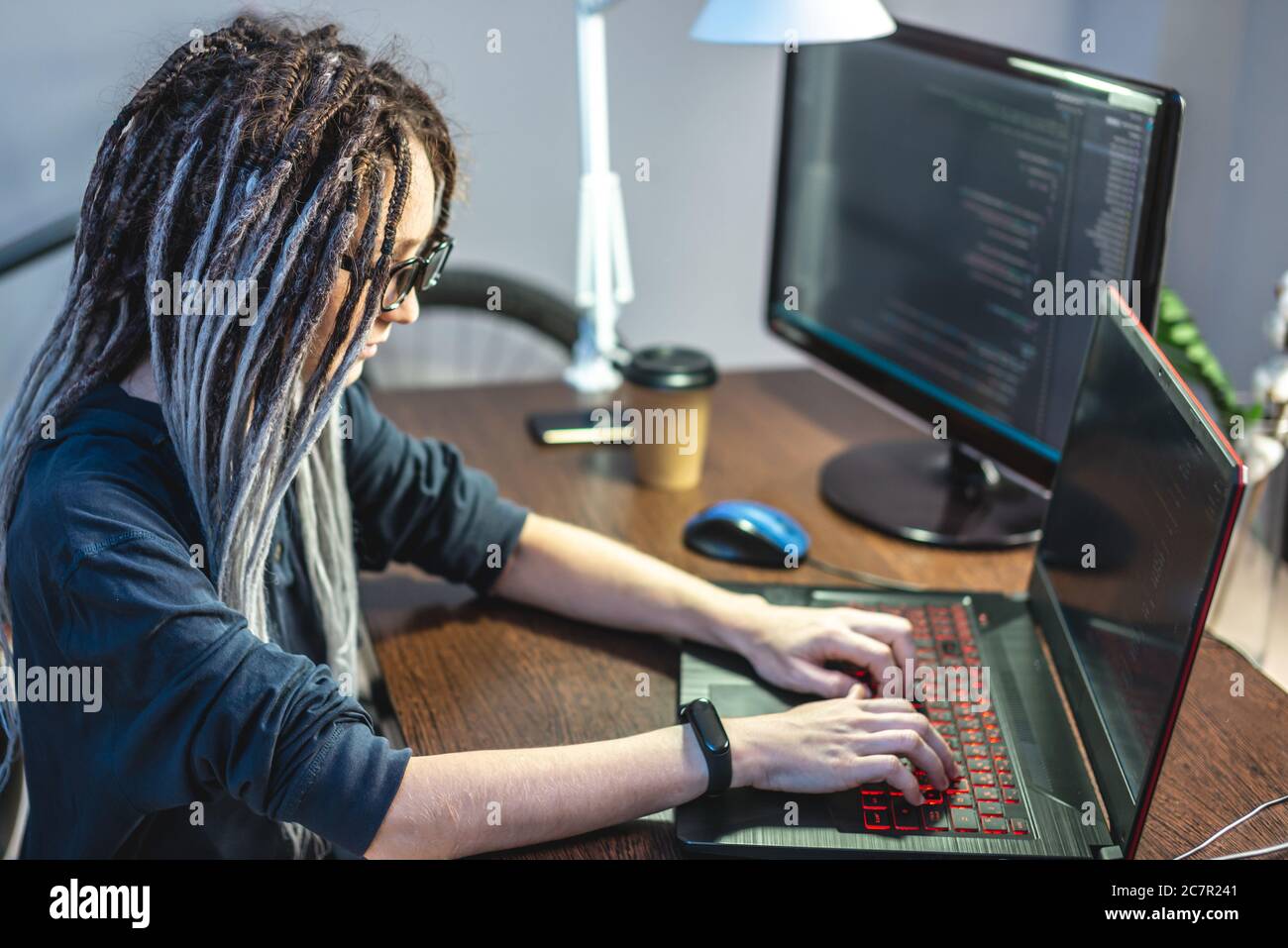 Modern Young Female Programmer Is Writing Program Code On A Laptop At