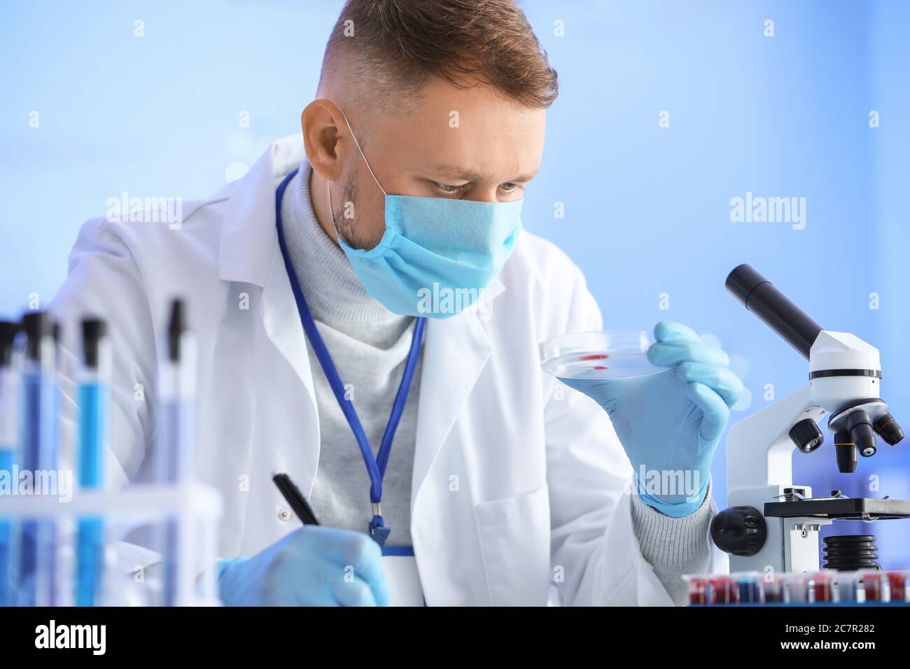 Scientist working with sample in laboratory Stock Photo - Alamy